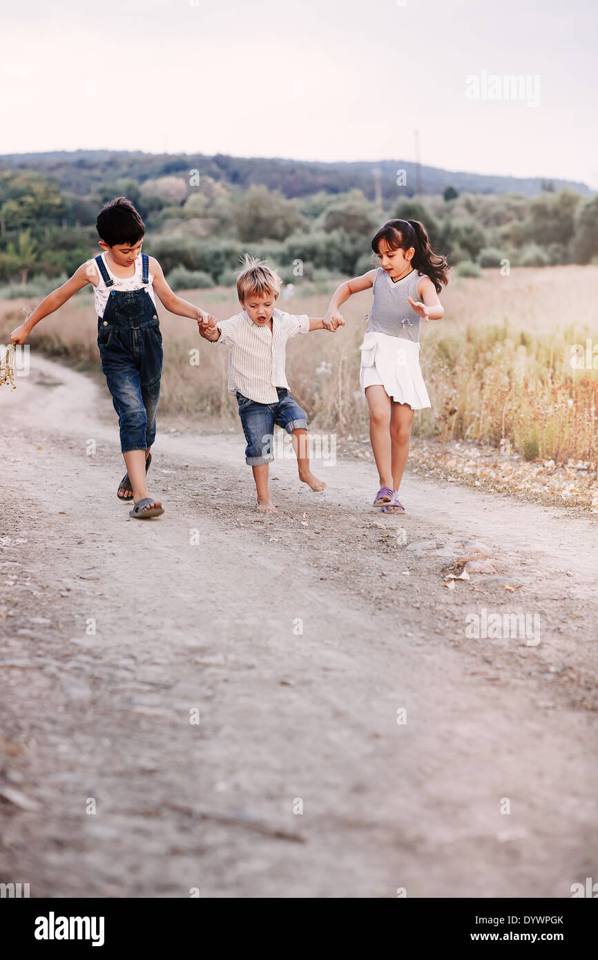 four children running outdoor Stock Photo - Alamy