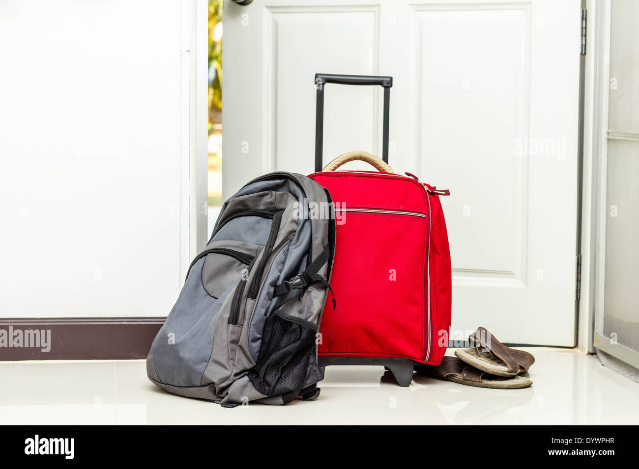 red travel bag , backpack and shoes by front door Stock Photo - Alamy