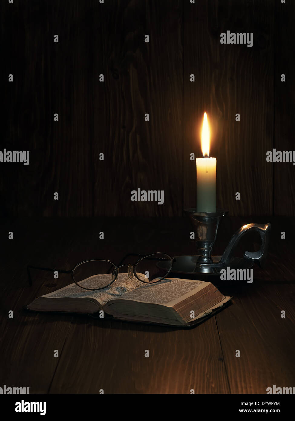Reading by candlelight Stock Photo - Alamy