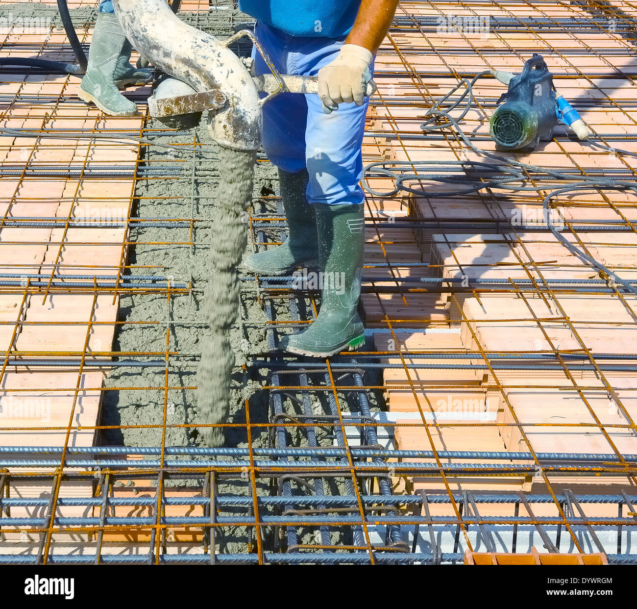 Workers pouring concrete on big floor construction on the construction ...