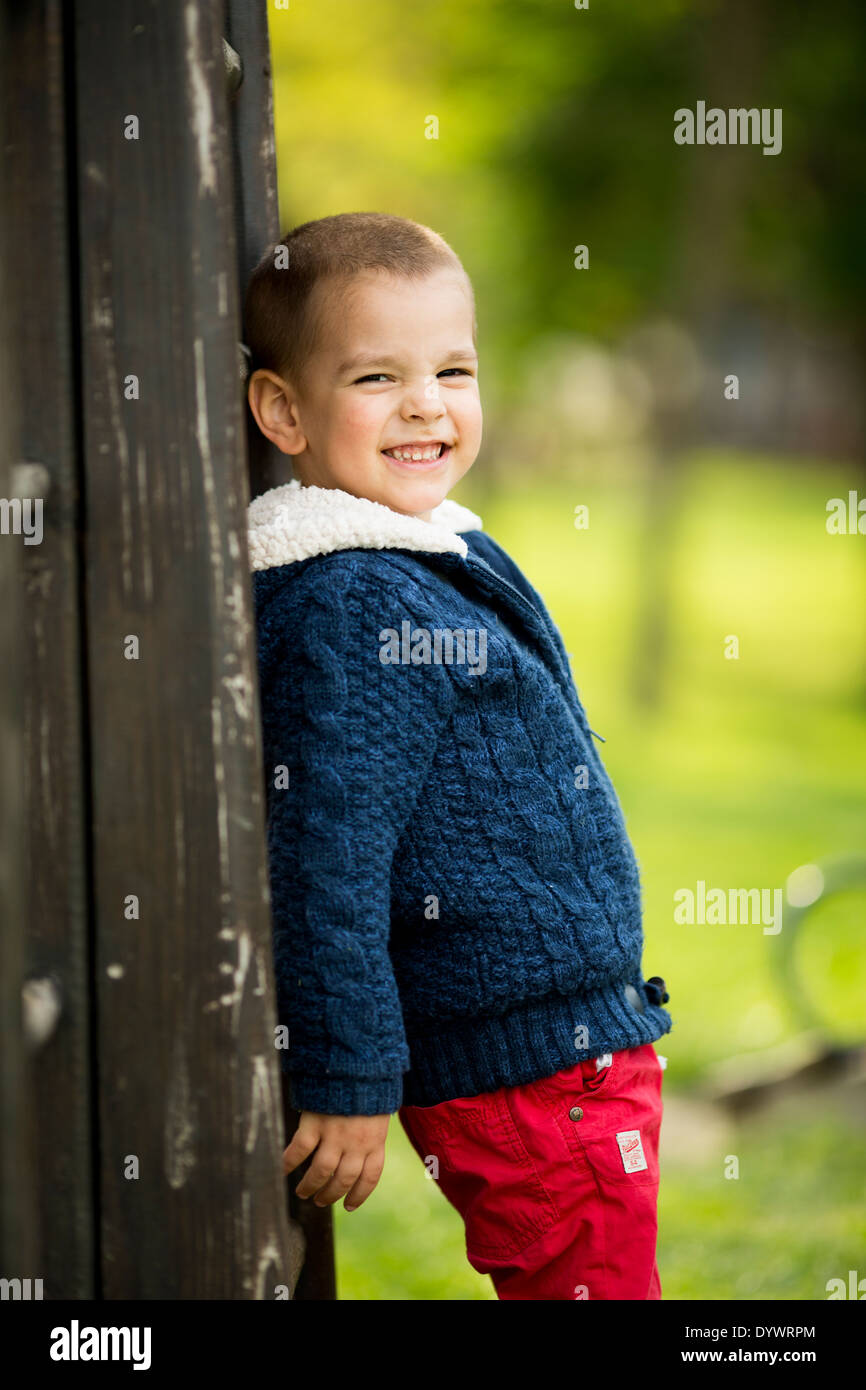 Cute boy by the tree Stock Photo - Alamy