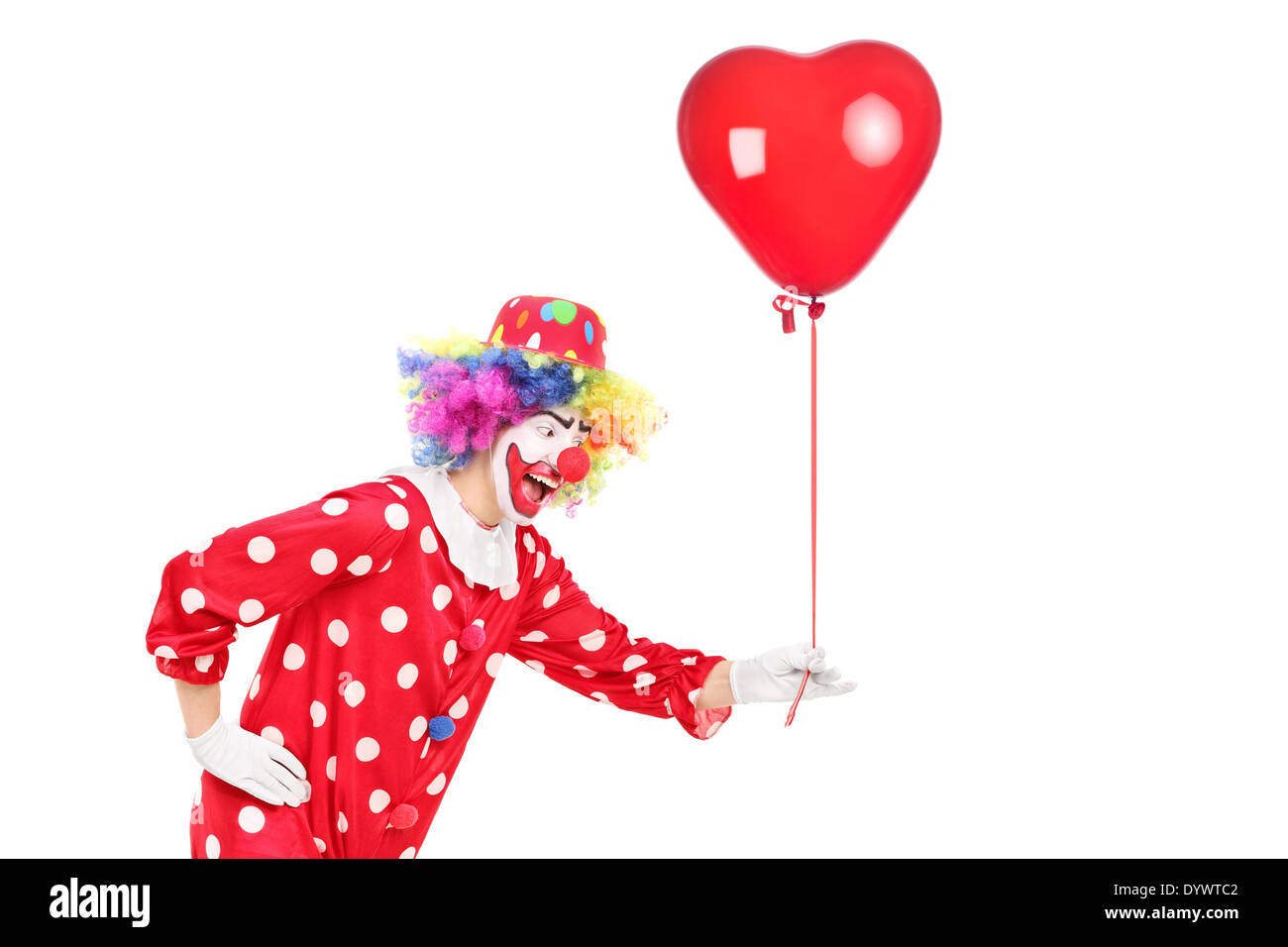 Male clown holding a red balloon Stock Photo - Alamy