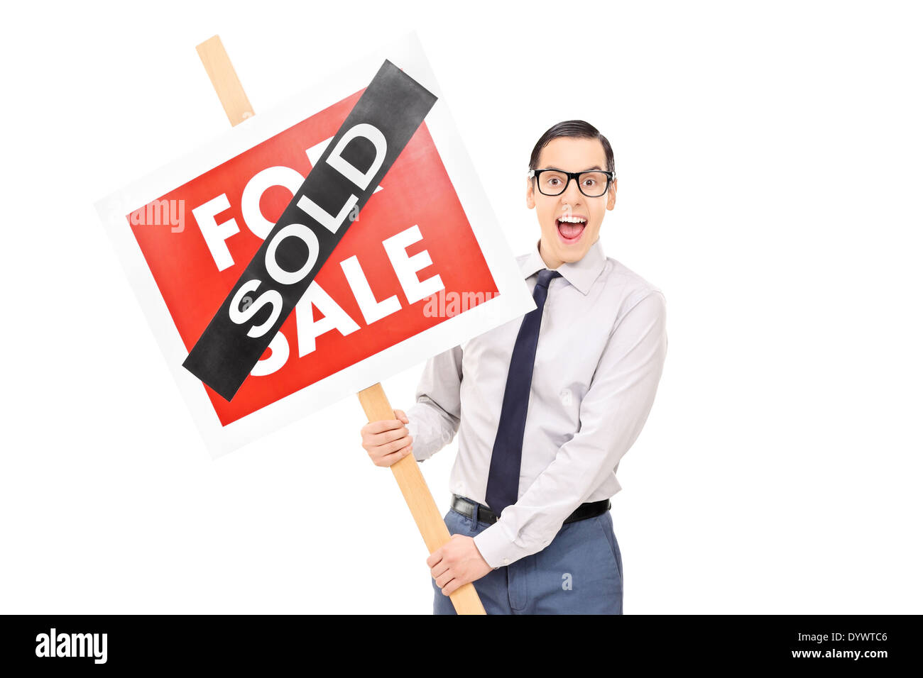 Male realtor holding a sold sign Stock Photo - Alamy