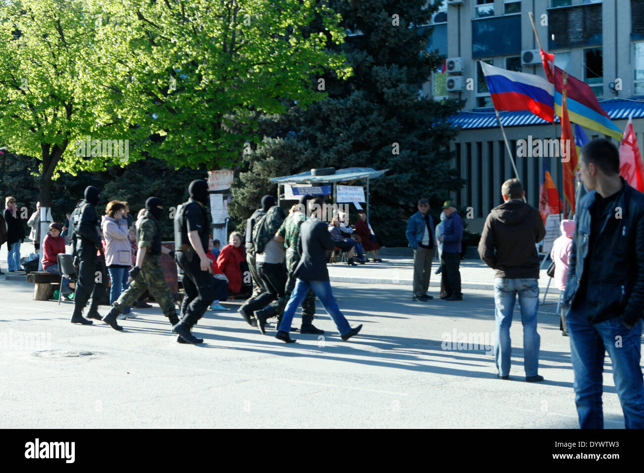 a group of armed and masked men bring a hooded man to the secret ...