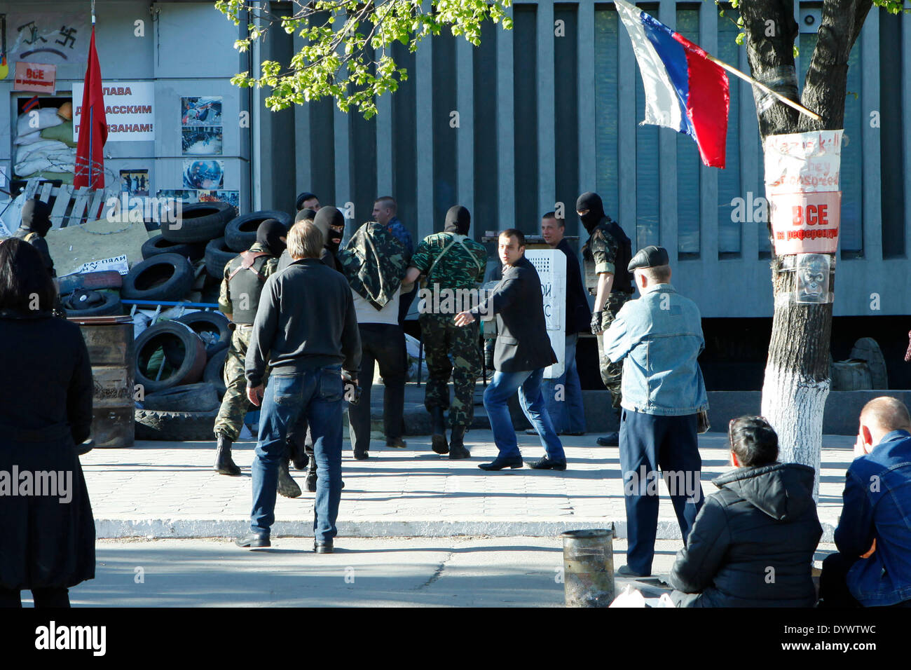 a group of armed and masked men bring a hooded man to the secret ...