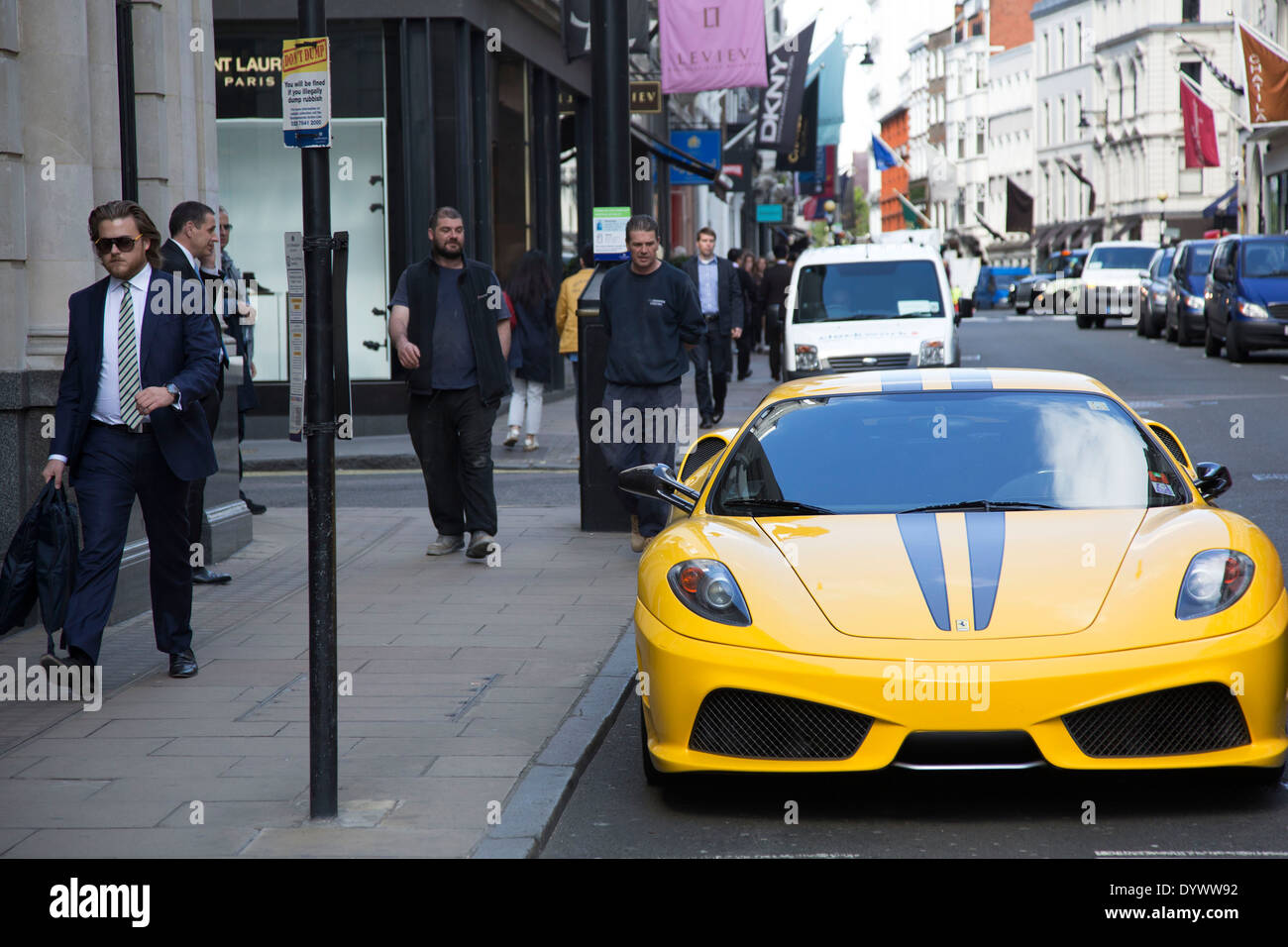 Yellow Ferrari supercar parked on Old Bond Street in Mayfair. London ...