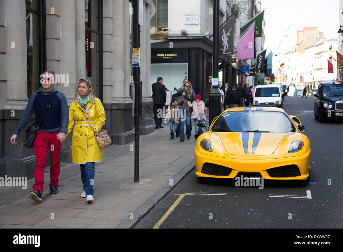 Yellow Ferrari supercar parked on Old Bond Street in Mayfair. London ...
