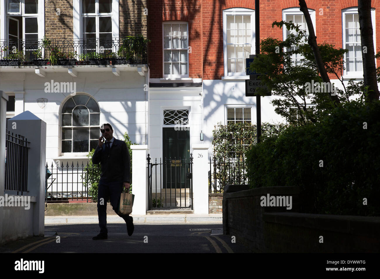 Silhouettes pass at the end of Kensington Church Walk. London, UK Stock ...