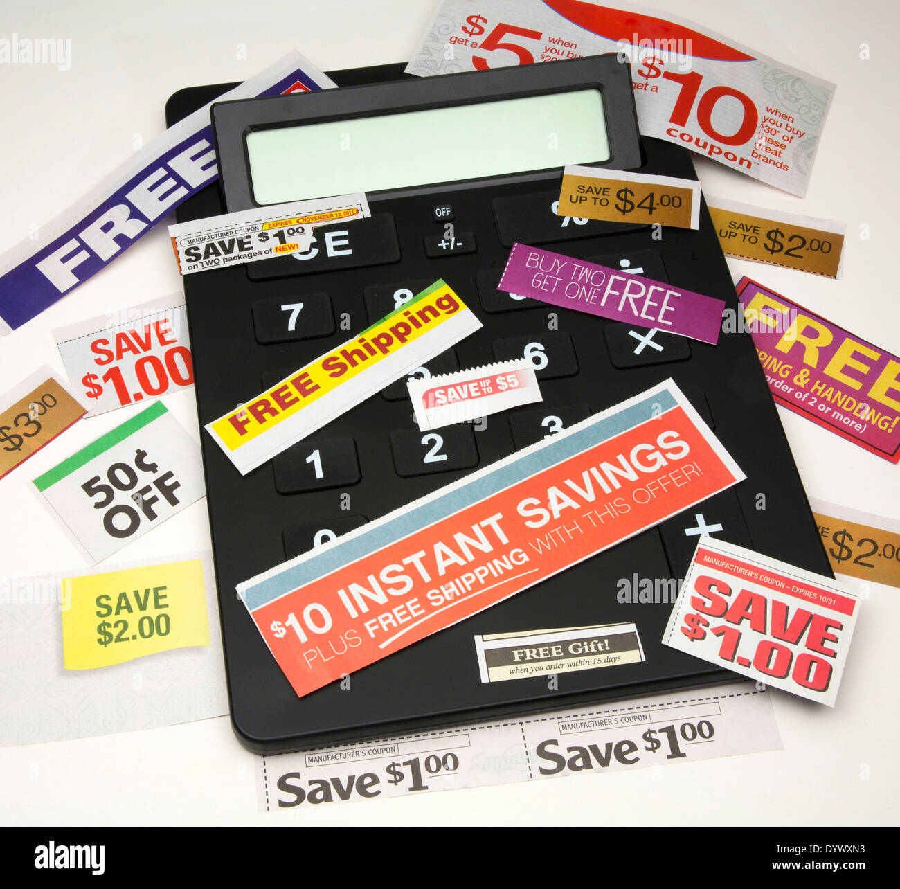 Calculator covered with cut out advertisements for savings Stock Photo ...