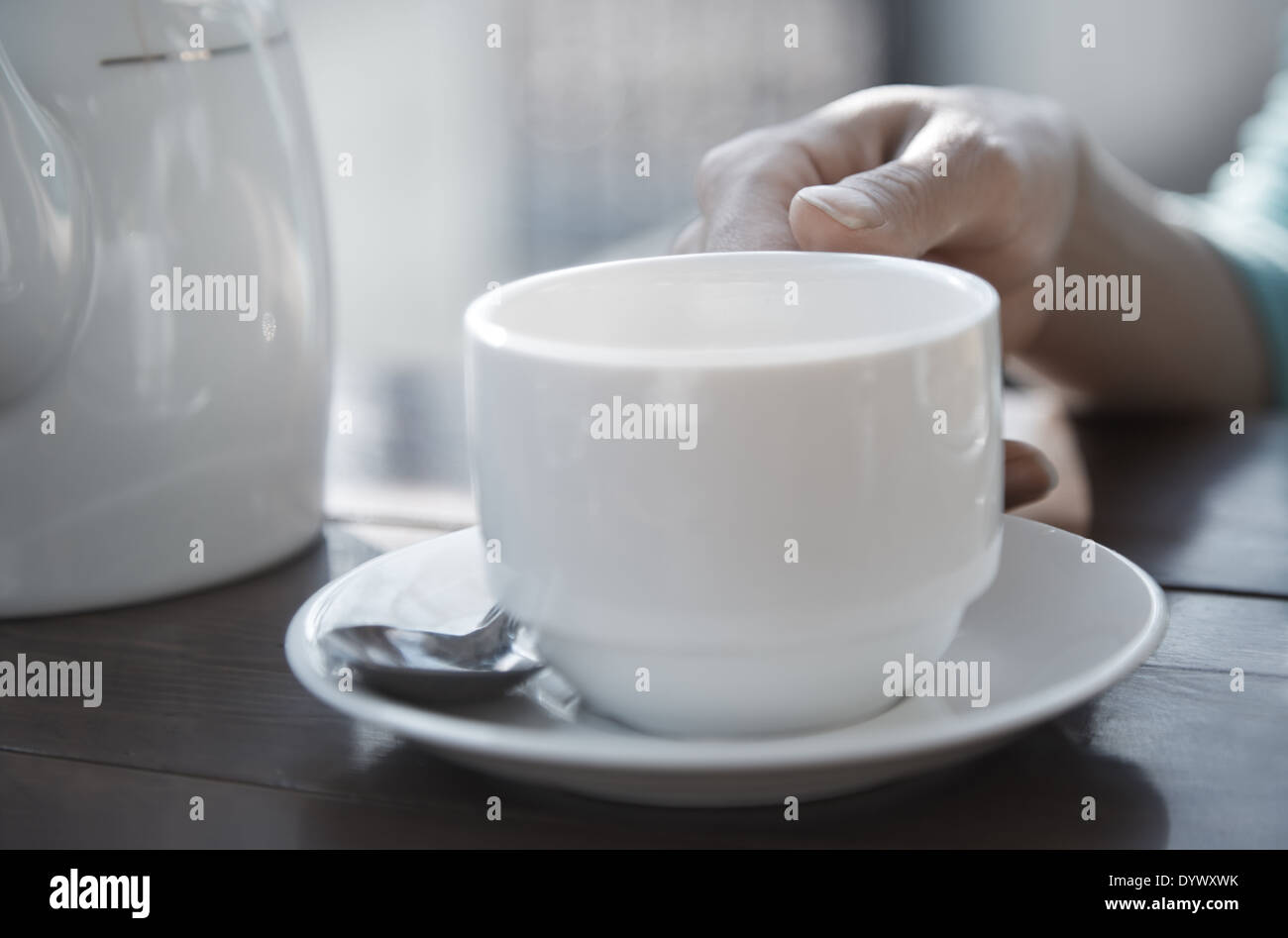 Woman hand holding teacup at outdoors cafe Stock Photo - Alamy