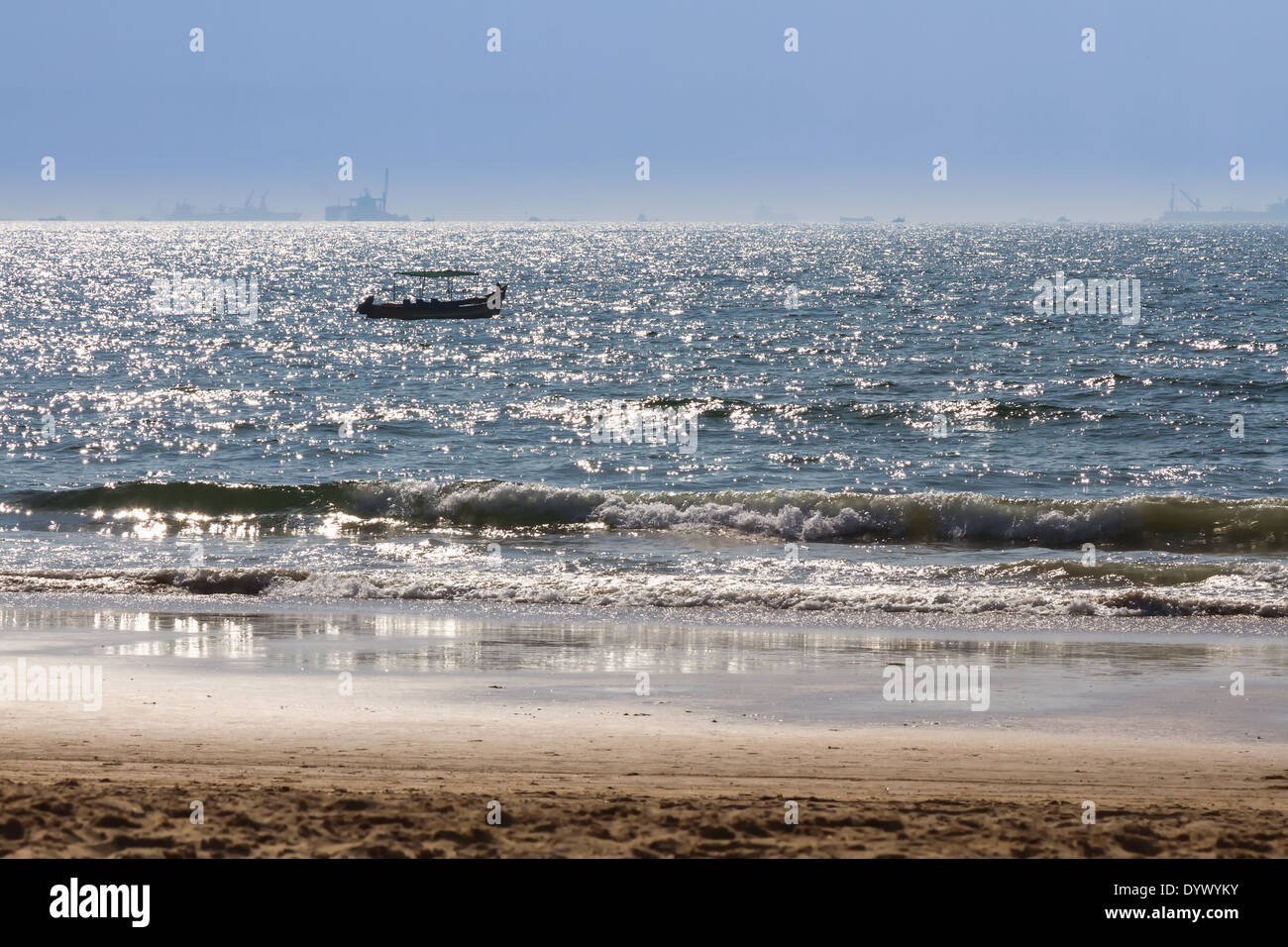 Boats at Arabian sea. Cargo ships on the background. View from beach in ...