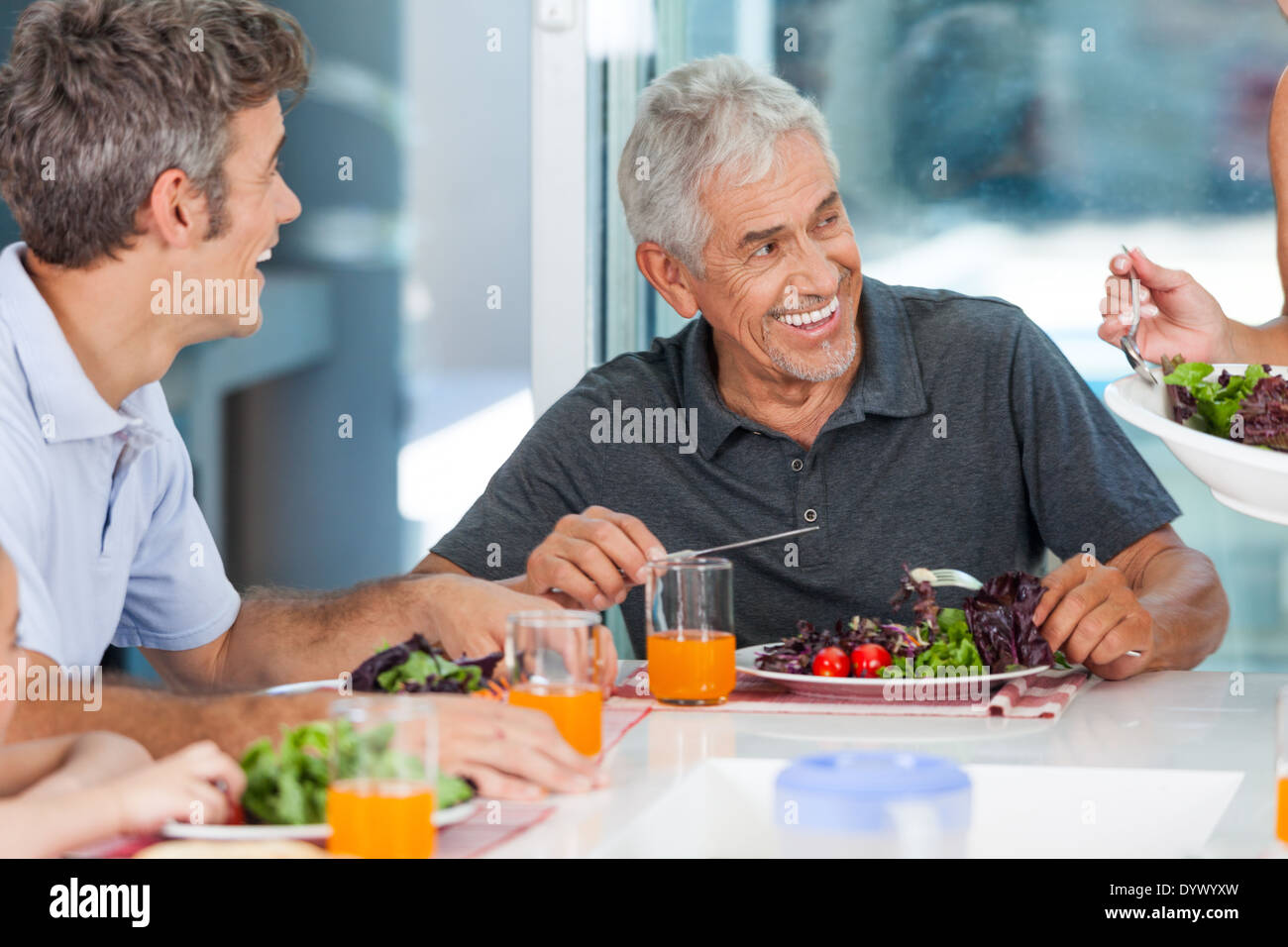 People laughing at dinner table hi-res stock photography and images - Alamy