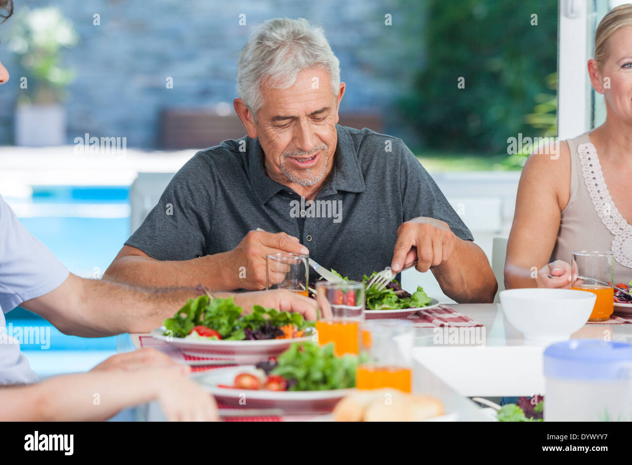 People laughing at dinner table hi-res stock photography and images - Alamy