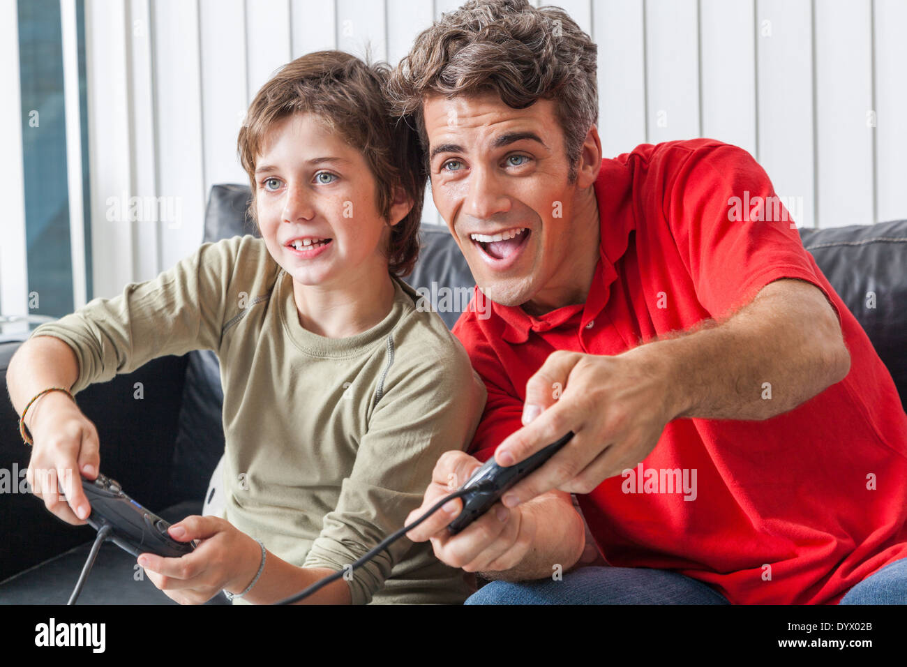 father and son playing video game Stock Photo - Alamy