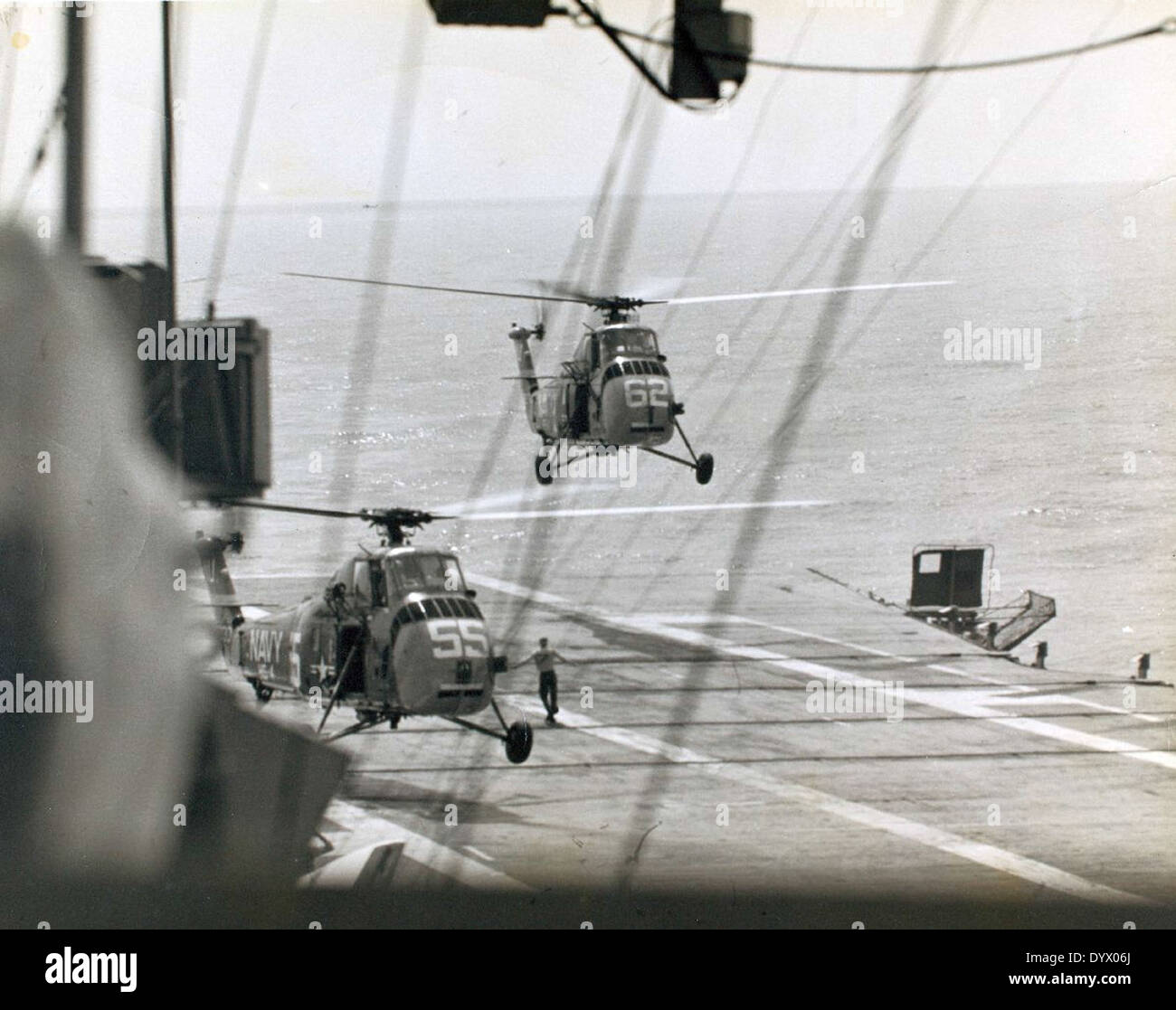 This photograph shows two H-34 helicopters aboard a naval ship ...