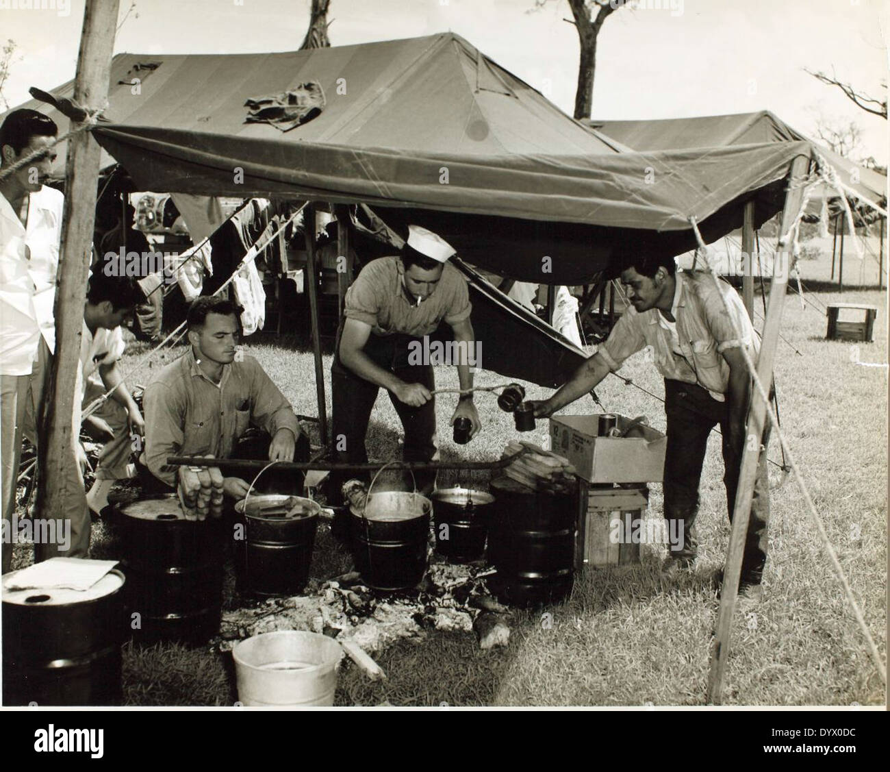 This image shows a temporary chow line set up in the aftermath of ...