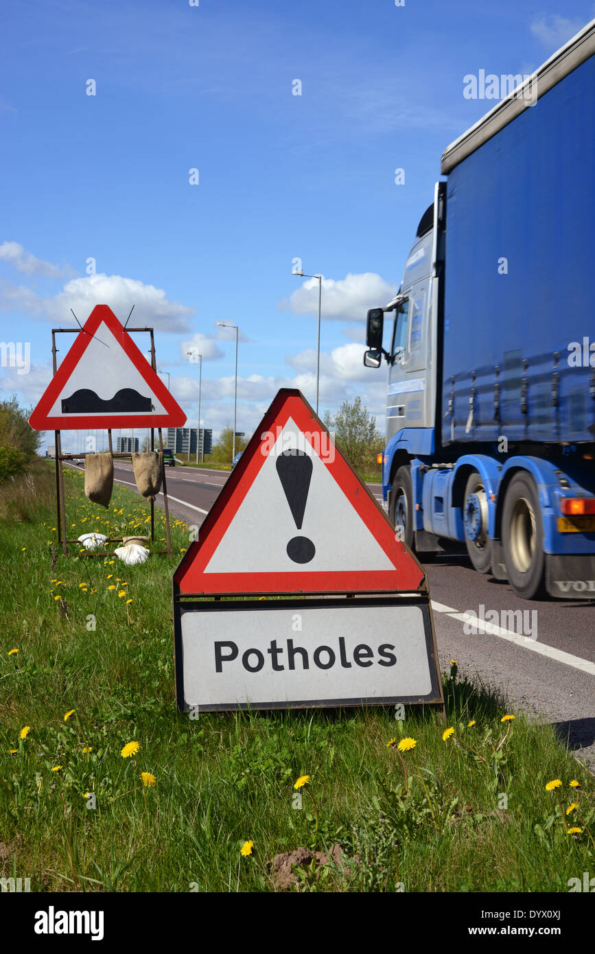 lorry passing pothole warning signs on road united kingdom Stock Photo ...