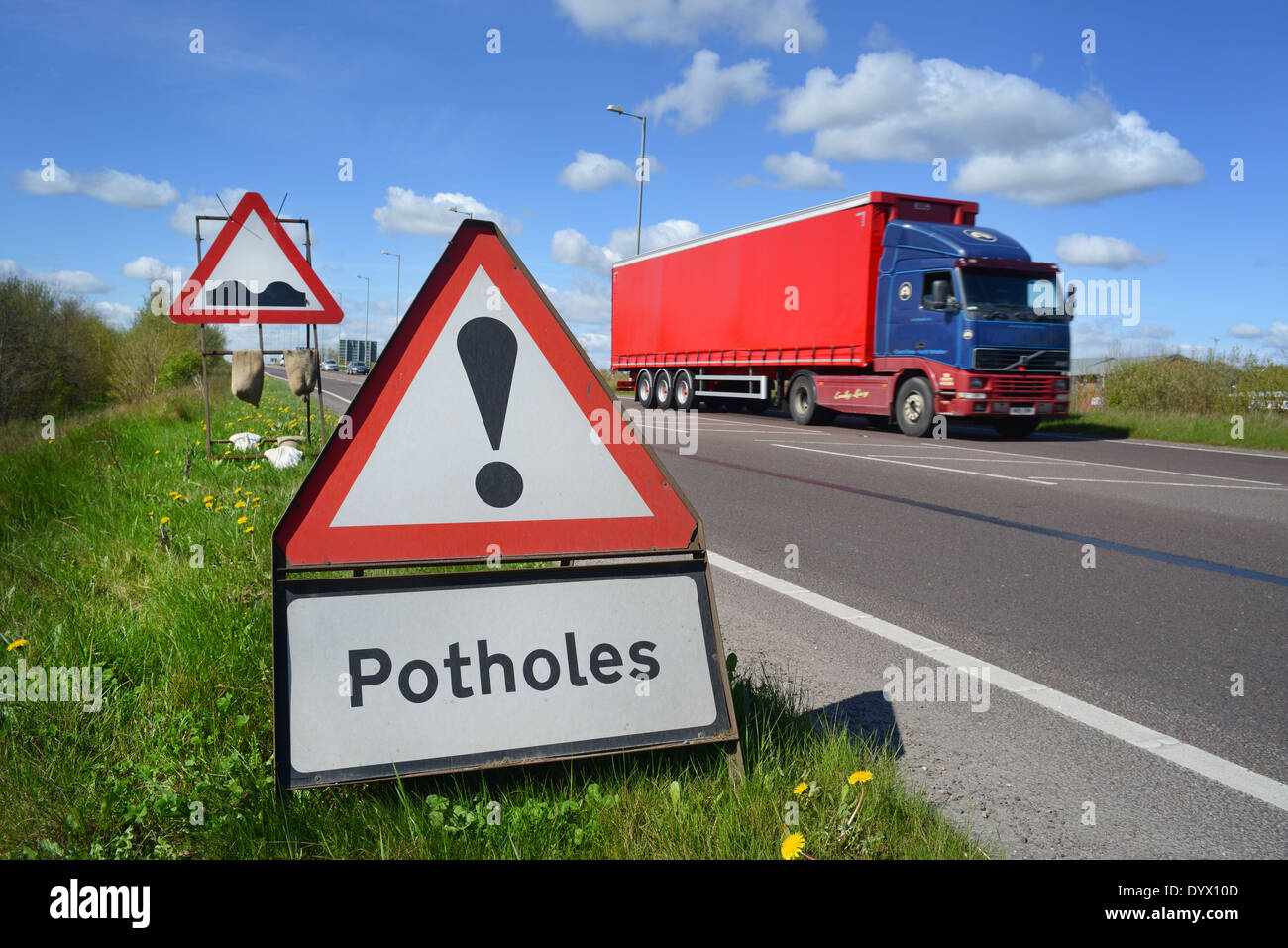 lorry passing pothole warning signs on road united kingdom Stock Photo ...