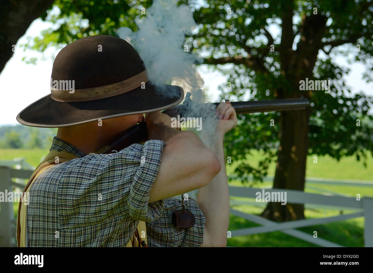 A man wearing period costume fires a musket gun. Ash-Lawn Highland ...