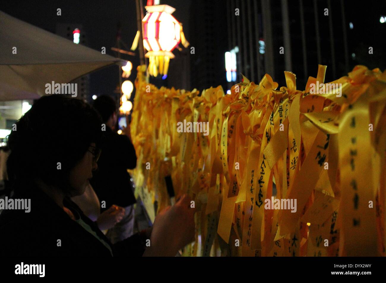Seoul, South Korea. 26th Apr, 2014. A woman fastens a yellow ribbon ...