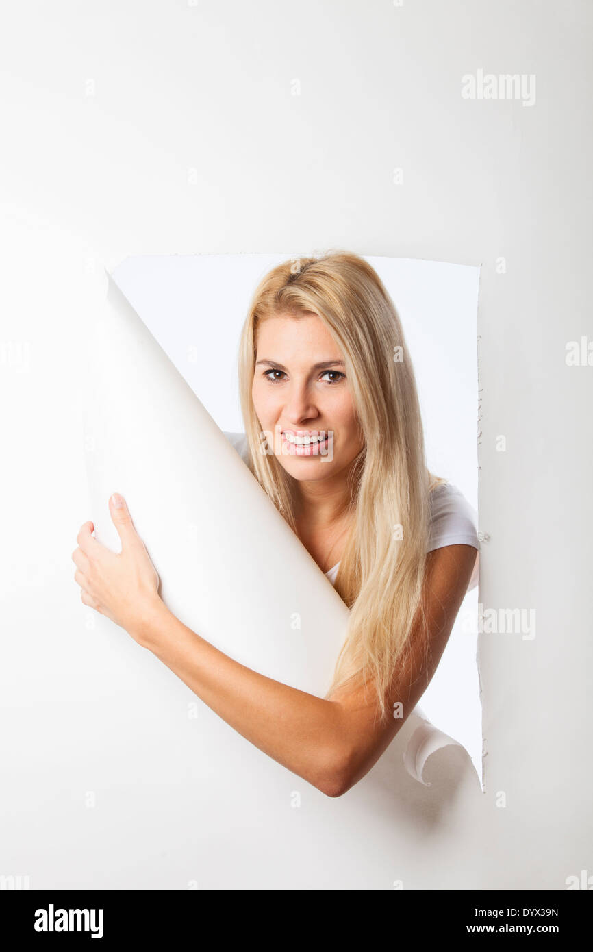 woman looking through seamless paper Stock Photo - Alamy