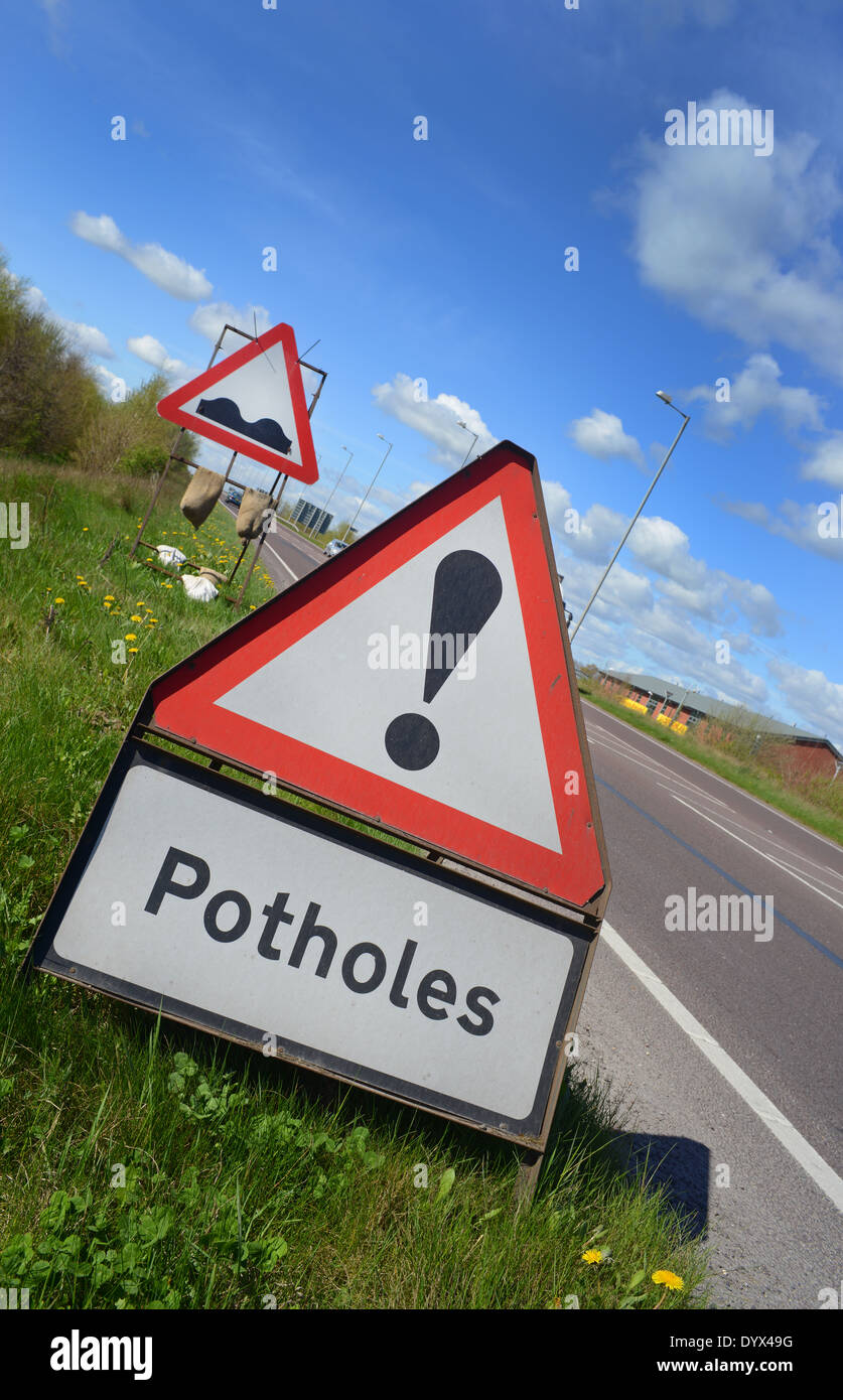 sign warning of pothole in road united kingdom Stock Photo - Alamy