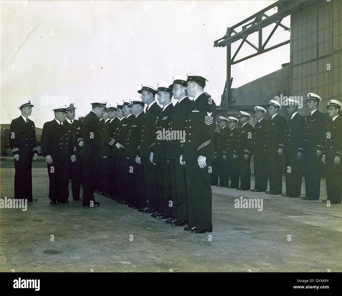 This image depicts an inspection at NAS NI, a key naval air station ...