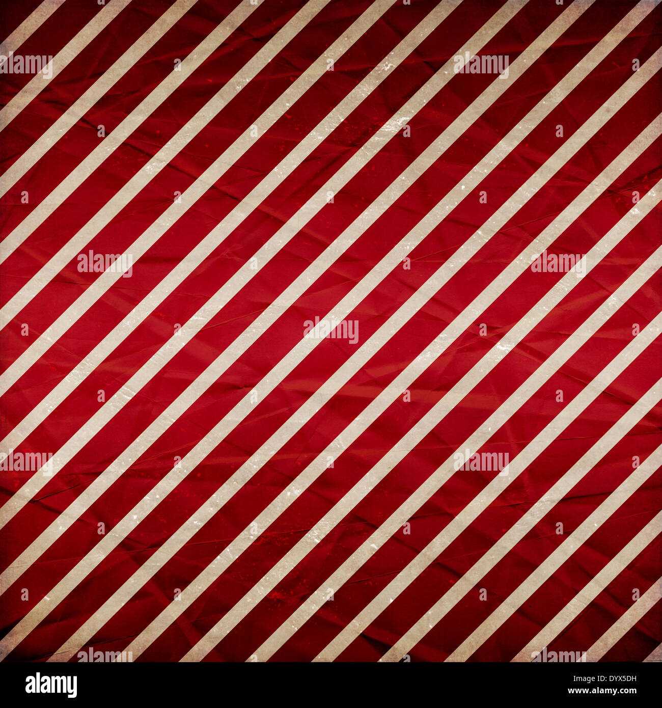 A crumpled paper in a red and white stripe pattern for use as a ...