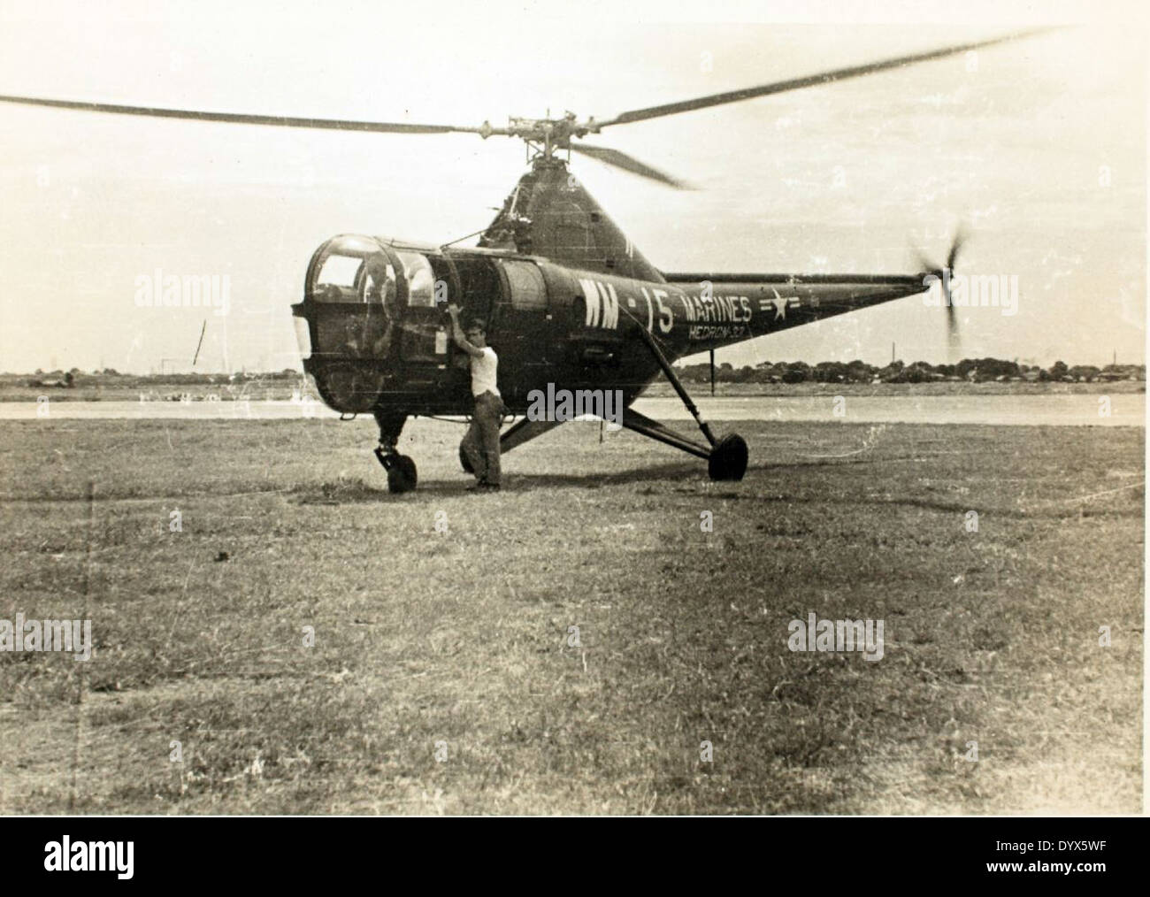 This photo captures a U.S. Navy HO3-S helicopter at Itami Airfield in ...