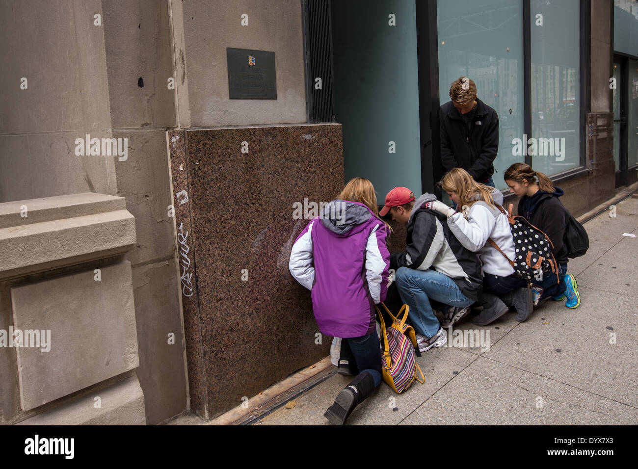 Young evangelists pray over a homeless man along South Michigan Avenue ...
