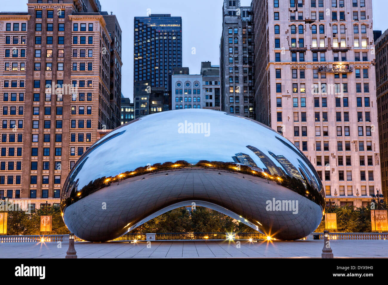 Cloud Gate Sculpture or The Bean with downtown skyline reflected in ...