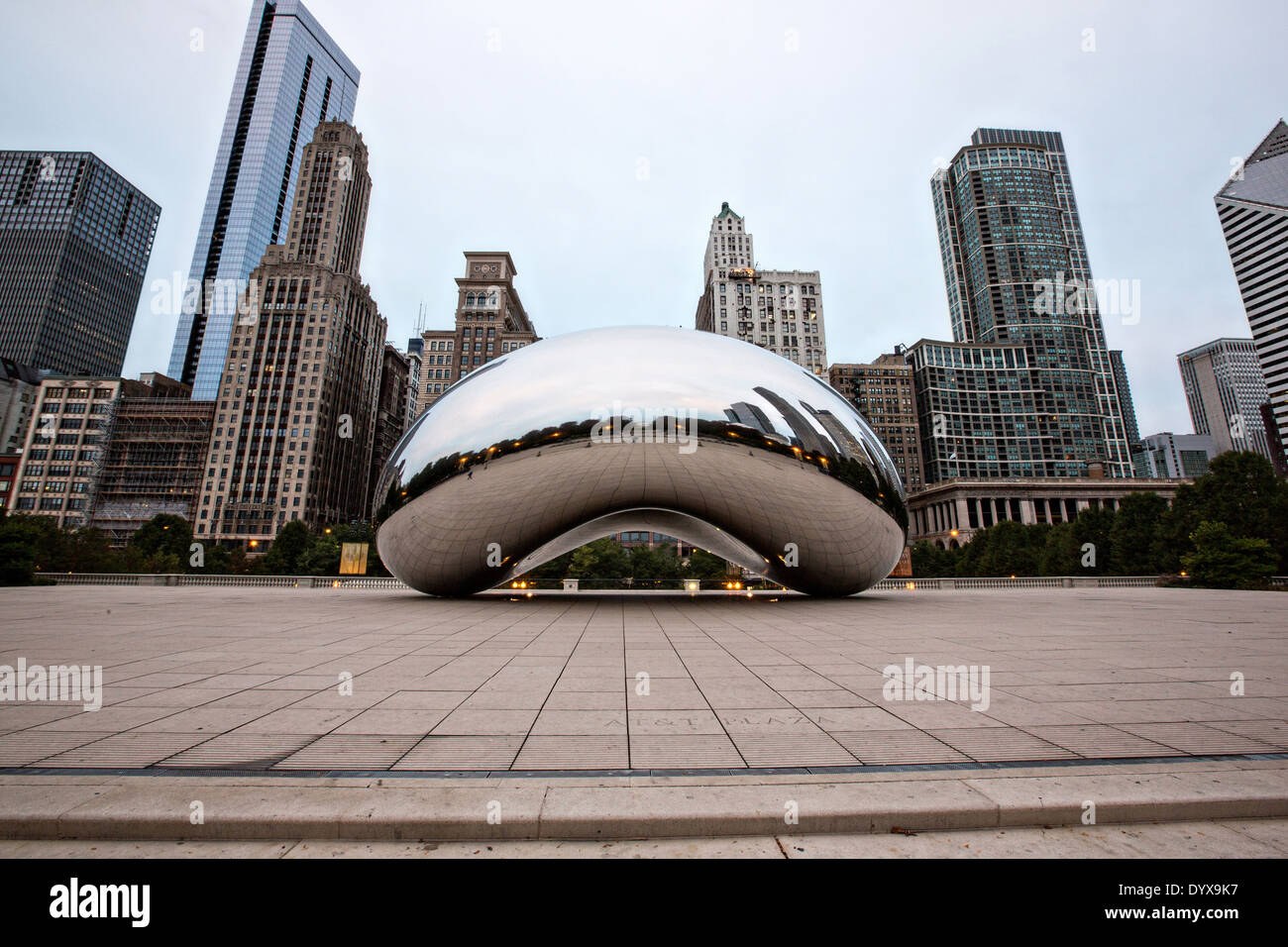 Cloud Gate Sculpture or The Bean with downtown skyline reflected in ...