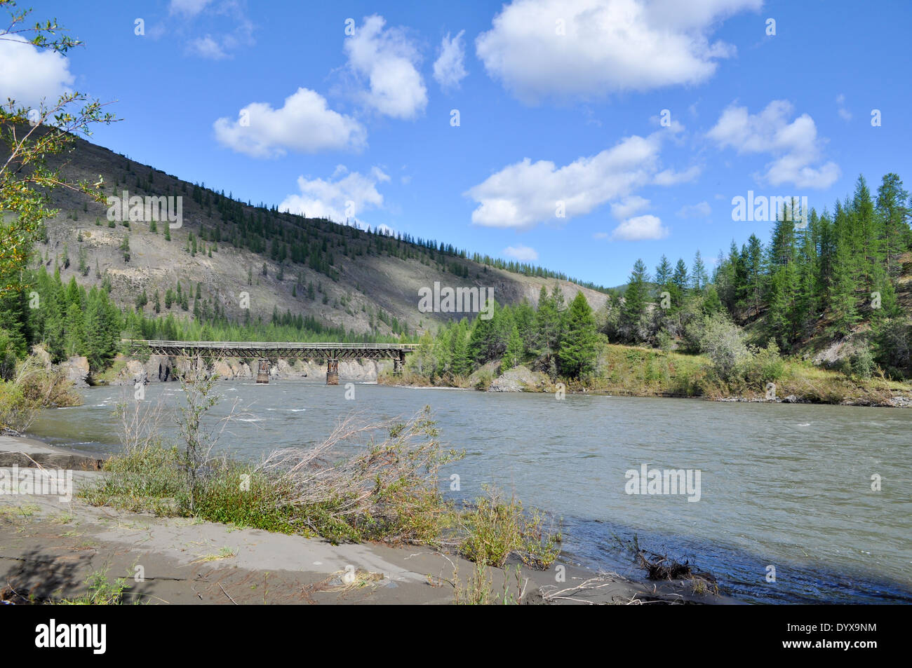 Bridge over the mountain river in Yakutia. Ridge Suntar-khayata, river ...