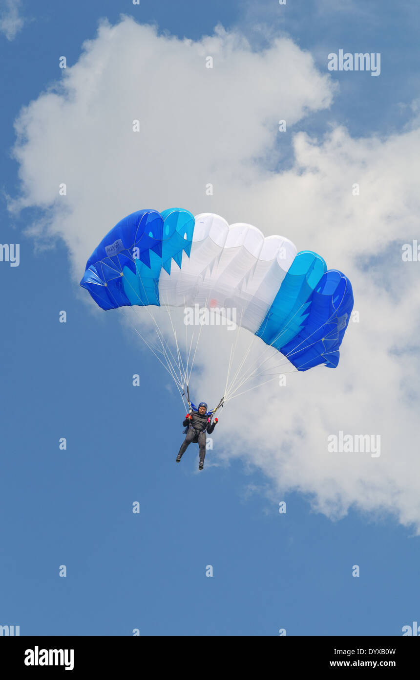 One day with parachutist in airfield. The skydiver lands under the ...