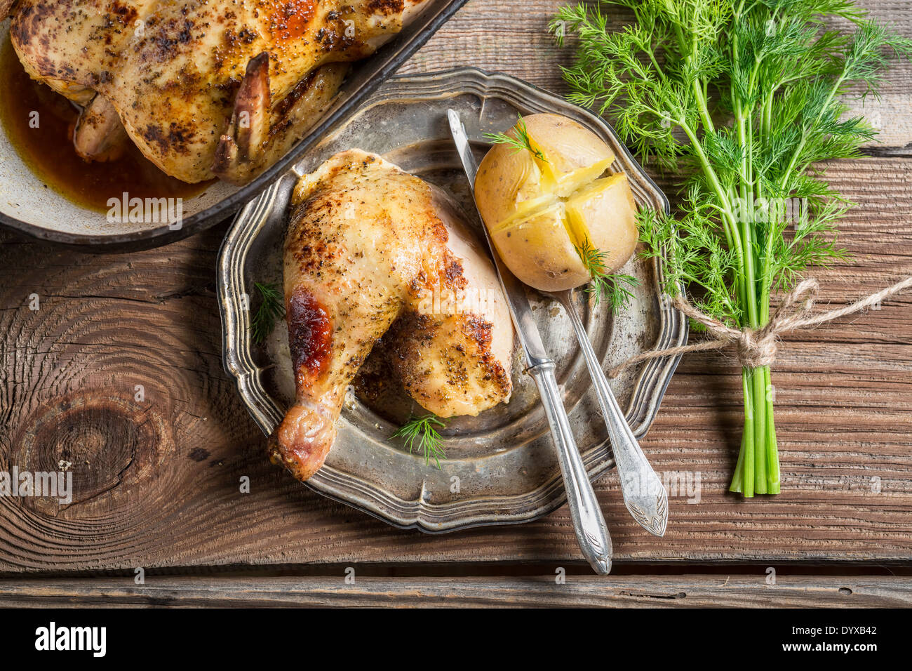 Roasted chicken and jacket potato Stock Photo - Alamy