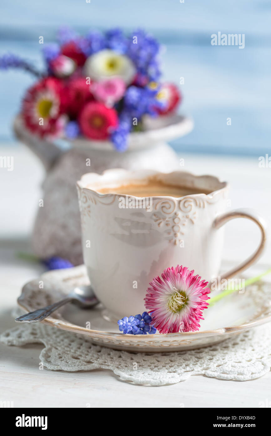 Cup of hot coffee and spring flowers Stock Photo - Alamy