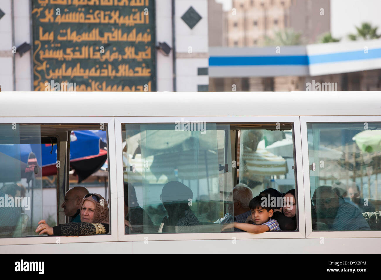 Baghdad. 26th Apr, 2014. Iraqi people look out of a mini bus in ...