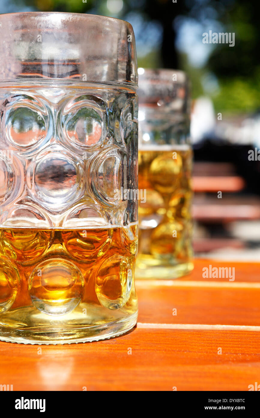 Half full beer mug in the beer garden in Bavaria Stock Photo - Alamy