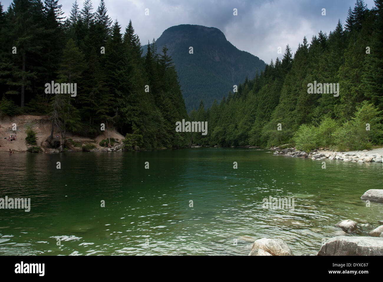 view up aqua-green calm inlet surrounded by forest with large high ...