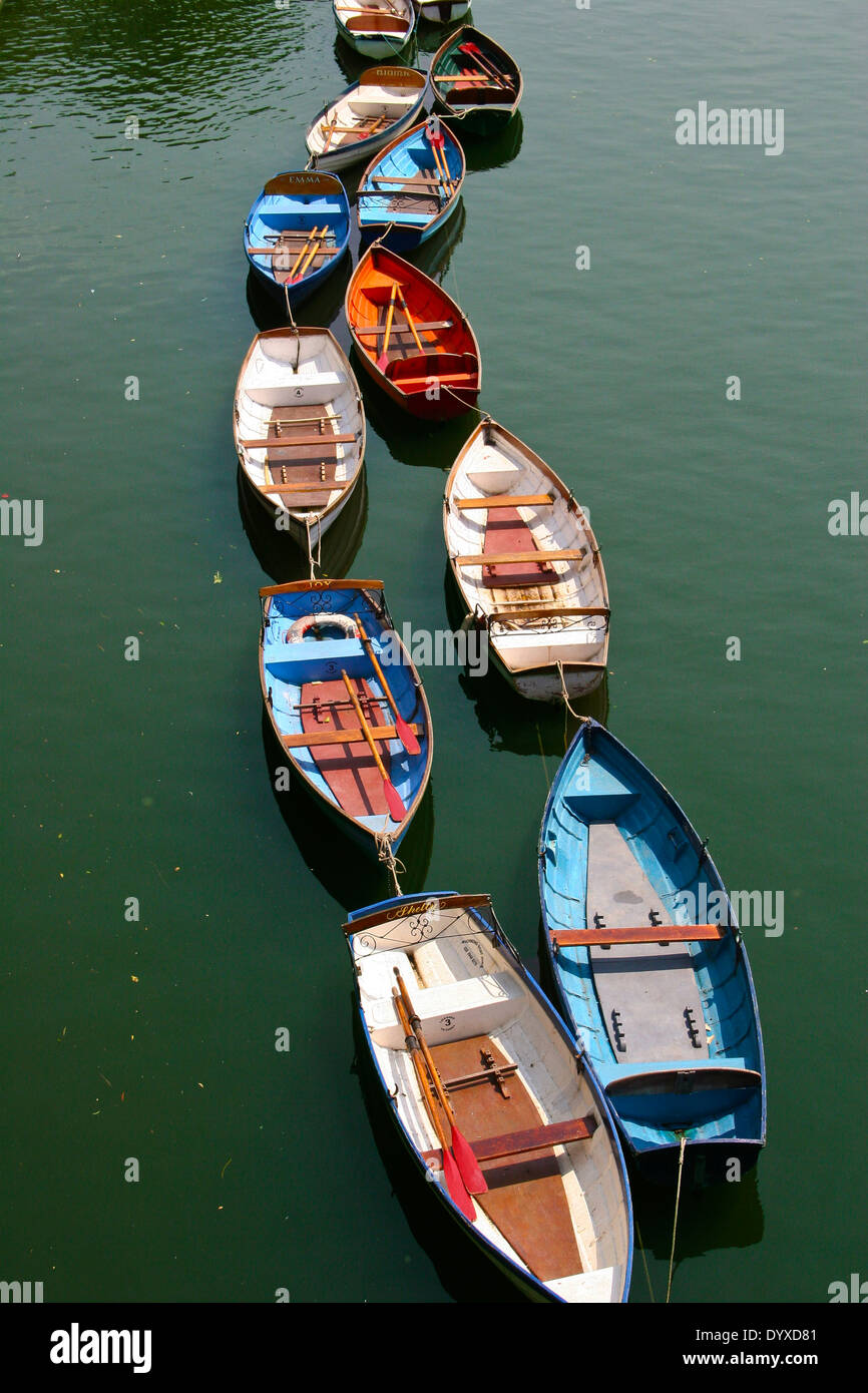 overhead photo of a curved row of brightly colored timber row boats ...