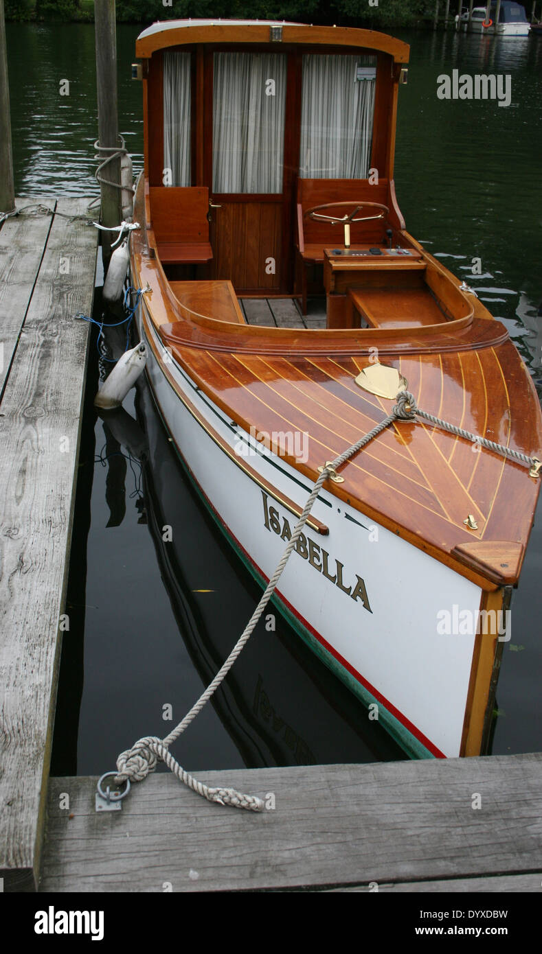 polished timber river boat tied up to wooden jetty in still river water ...