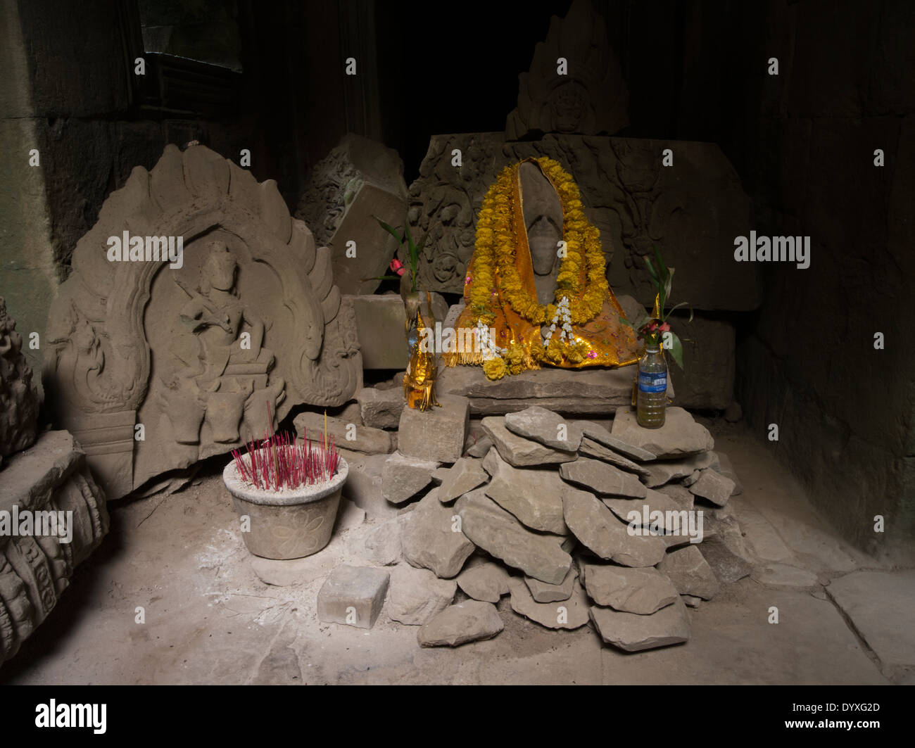 Buddhist statues inside Ta Prohm temple ruin in the forest. Siem Reap ...