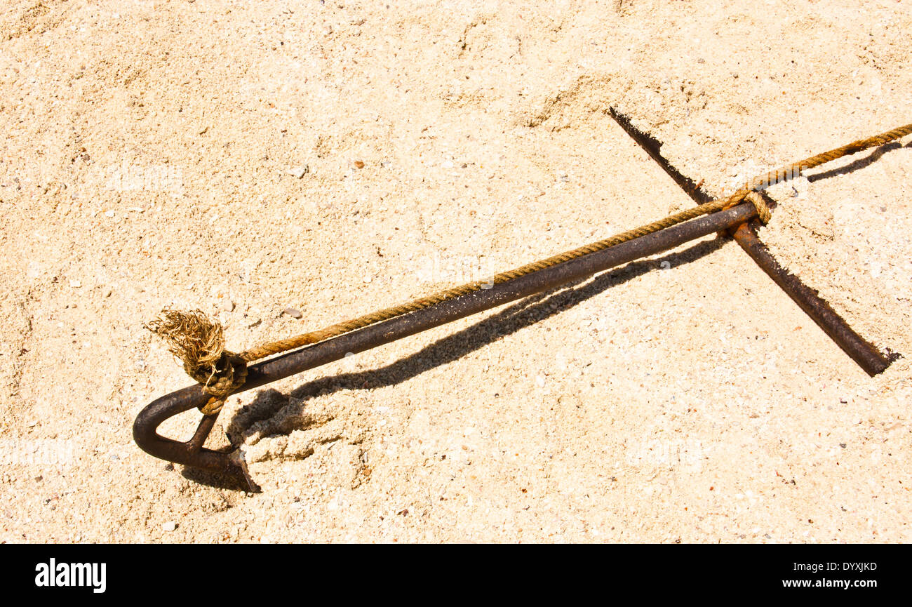 Old rusty anchor embroidered on the beach Stock Photo - Alamy