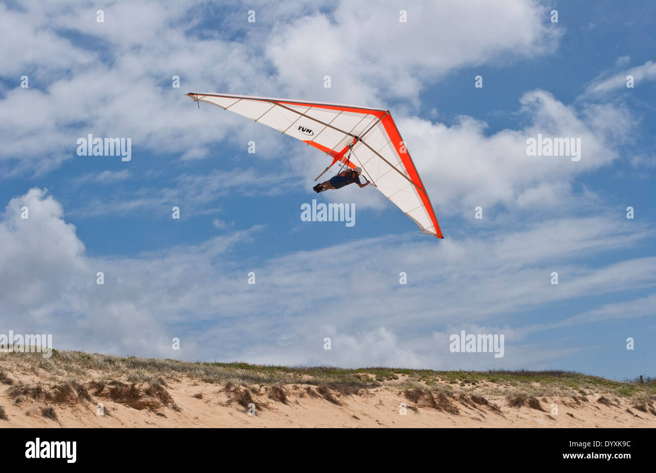 hang-glider flying very low along beach sand-dunes on a sunny day Stock ...