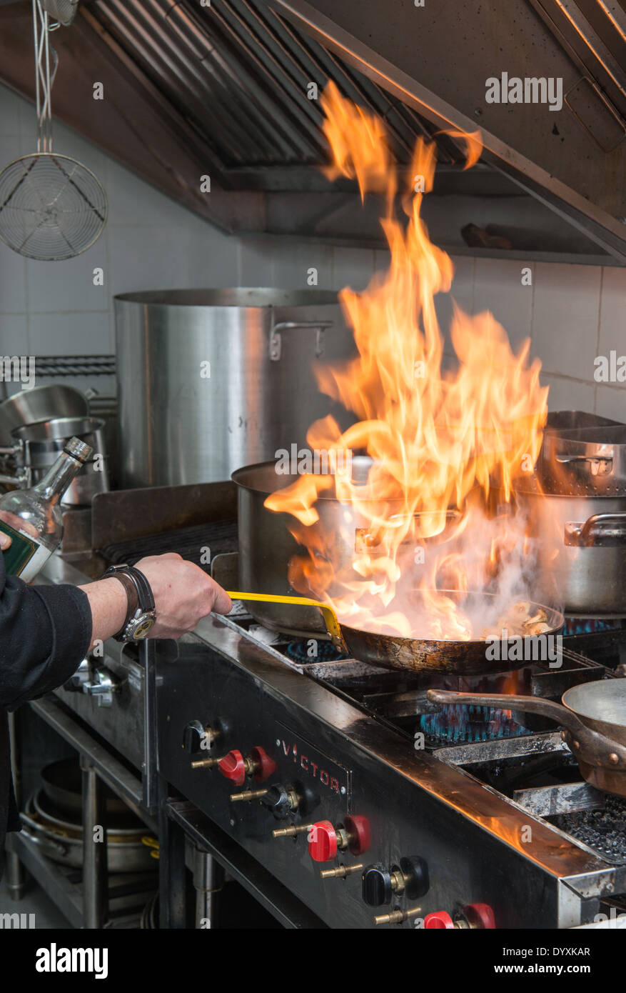 flambe cooking in a restaurant Stock Photo - Alamy