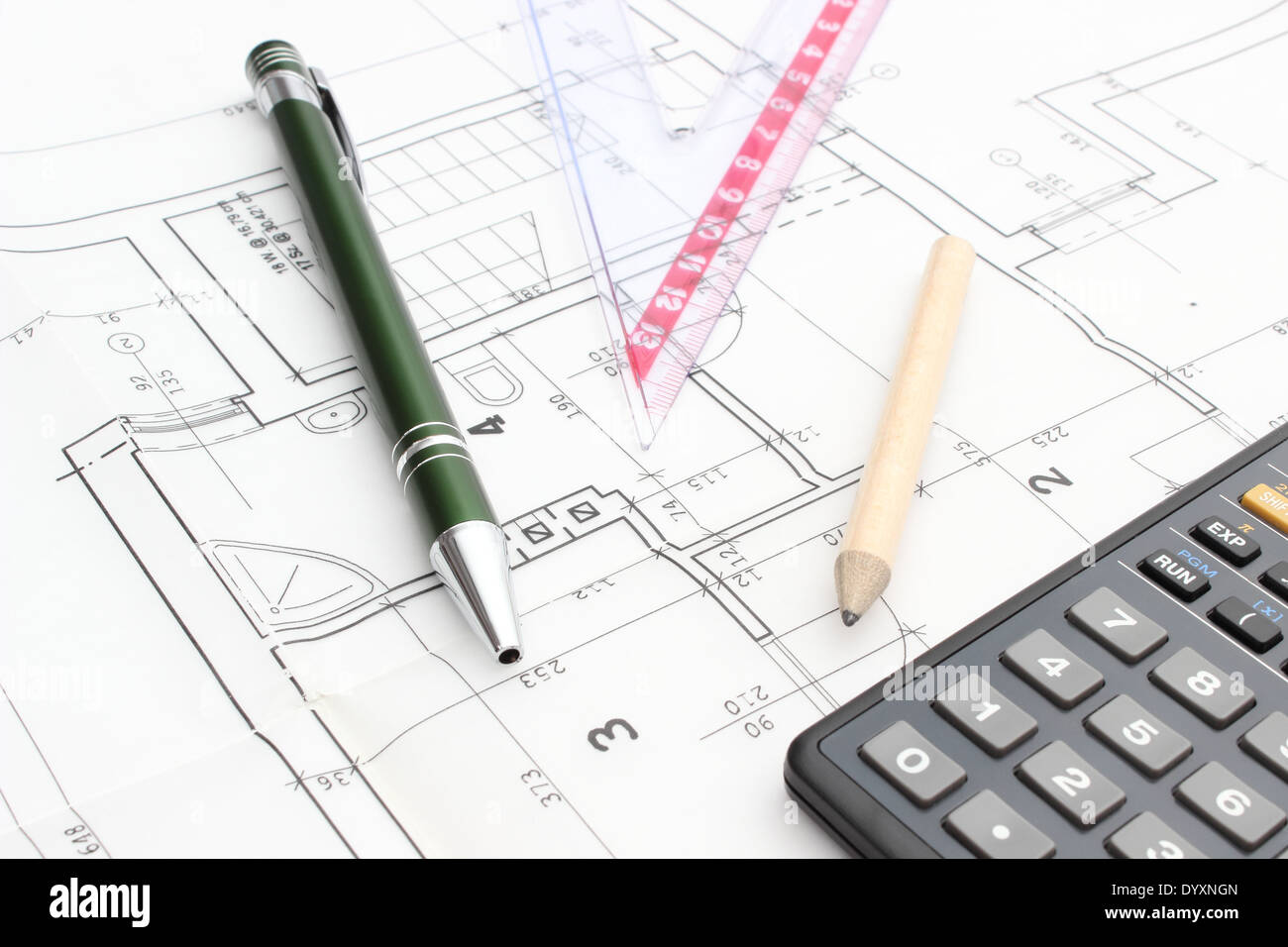 Drawing accessories and calculator on construction drawing of house ...