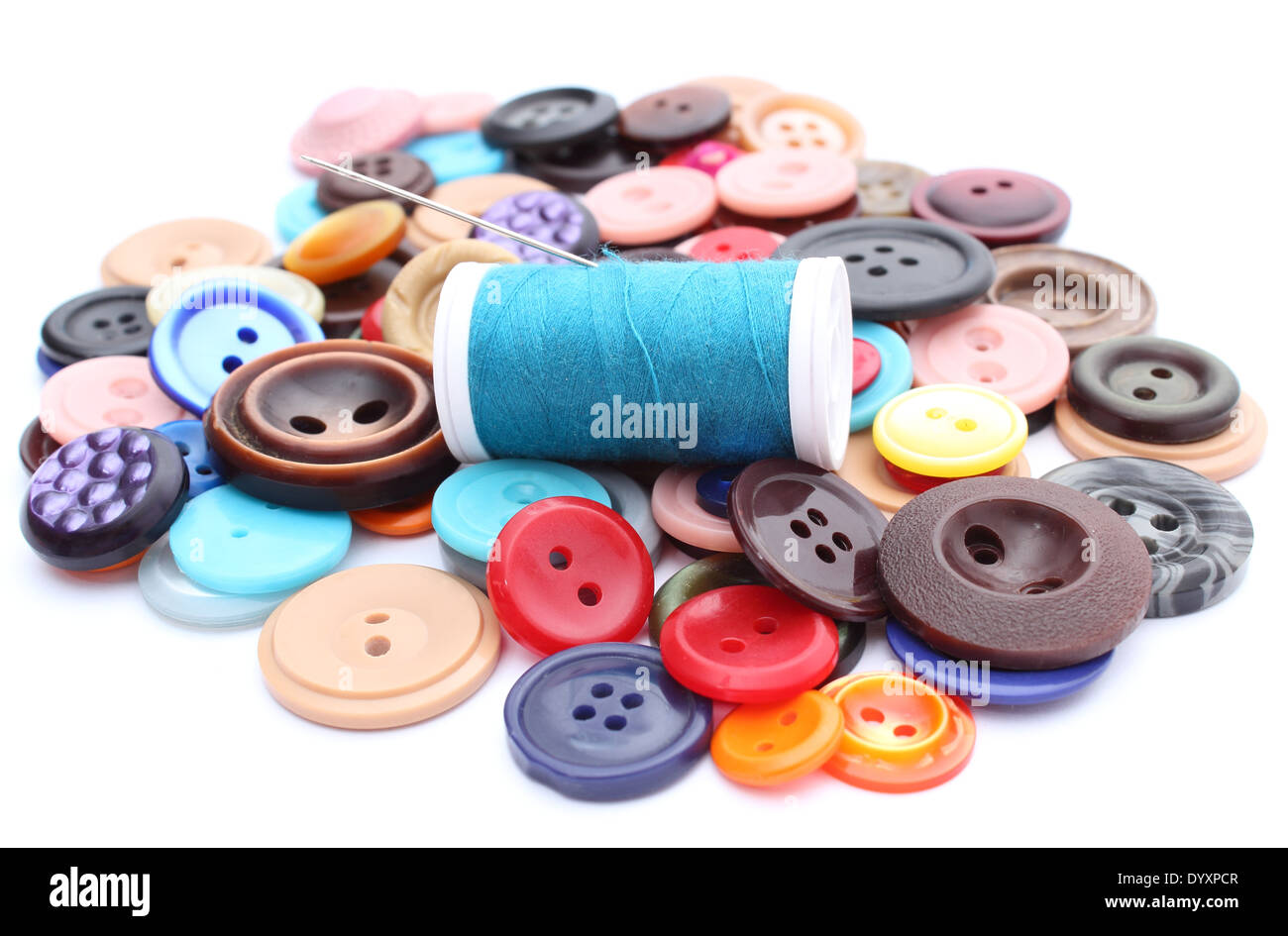 Closeup of blue thread with needle and collection of various sewing ...