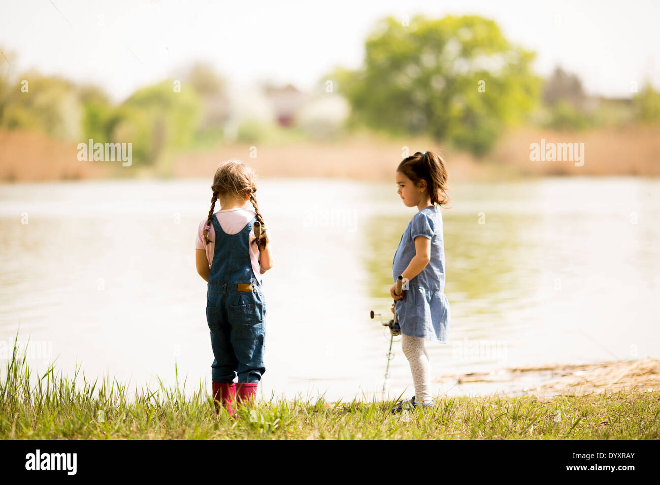 Two little girls fishing Stock Photo - Alamy