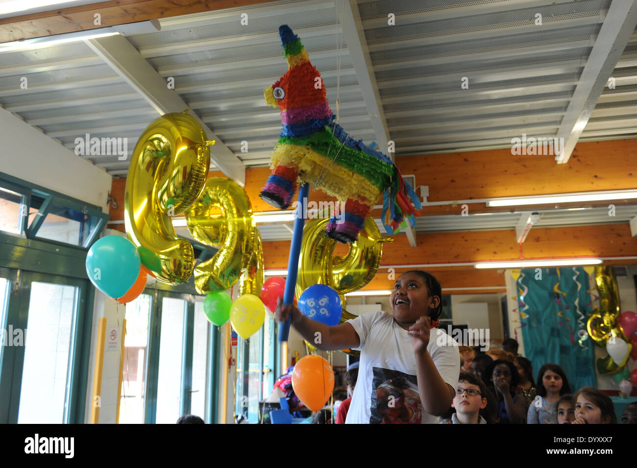 Boy swinging at pinata hi-res stock photography and images - Alamy