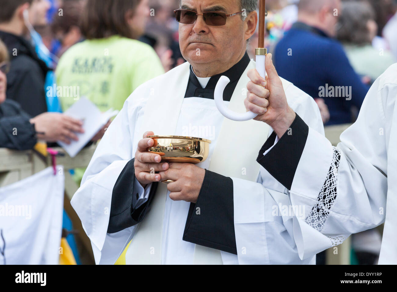 Priest carrying chalice containing the host Stock Photo - Alamy